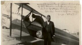 Oscar DePriest poses in front of a plane located on an airfield in Los ...