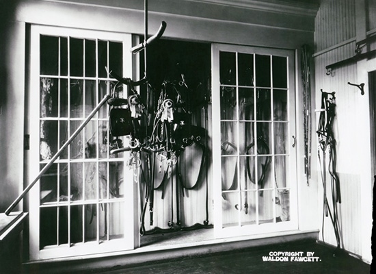 Harness room in the Roosevelt stables, 1903. Visible in the case were ...